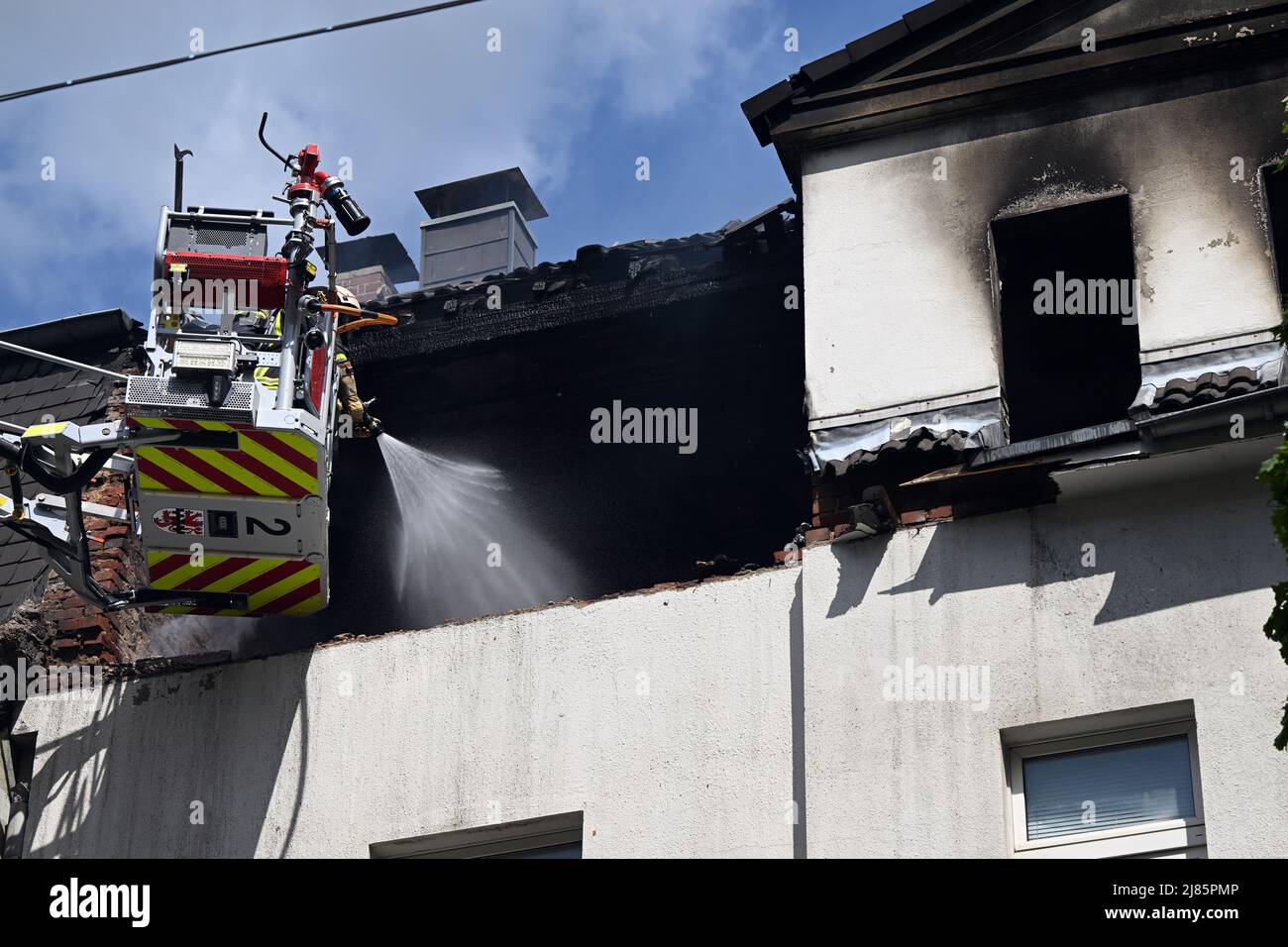 Leverkusen, Germany. 13th May, 2022. Firefighters extinguish a fire in ...