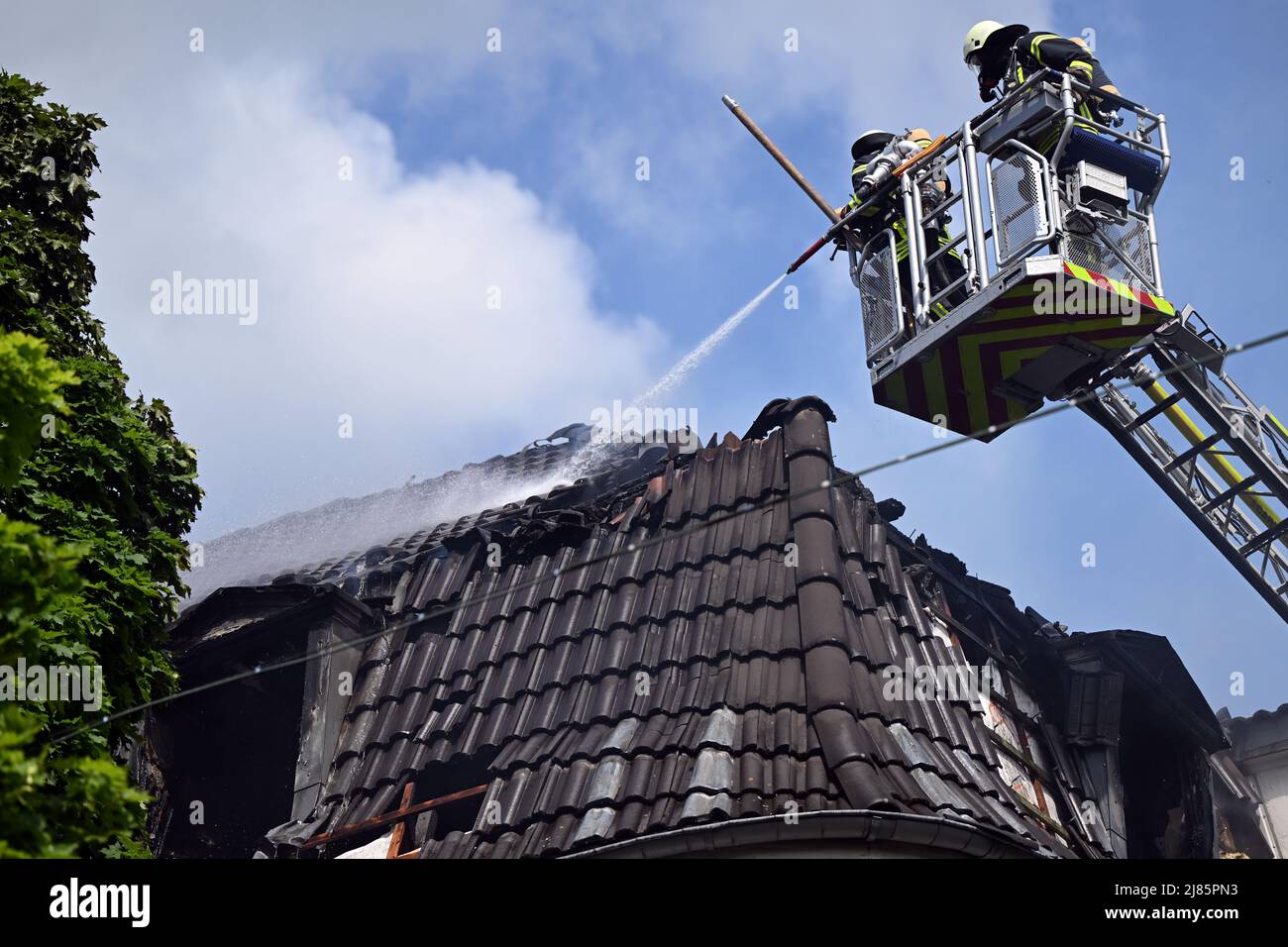 Leverkusen, Germany. 13th May, 2022. Firefighters extinguish a fire in ...