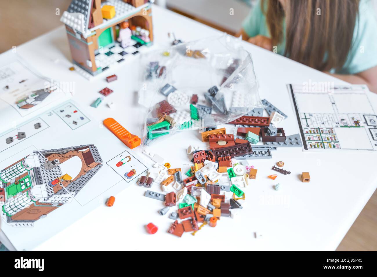 Girls, sisters play kids constructor, build house Lego Harry Potter ...