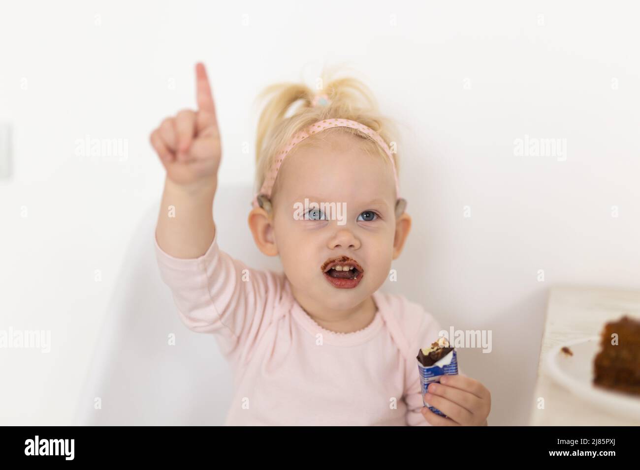 Cochlear implant for baby. Deaf child with hearing aid. Health care and ...