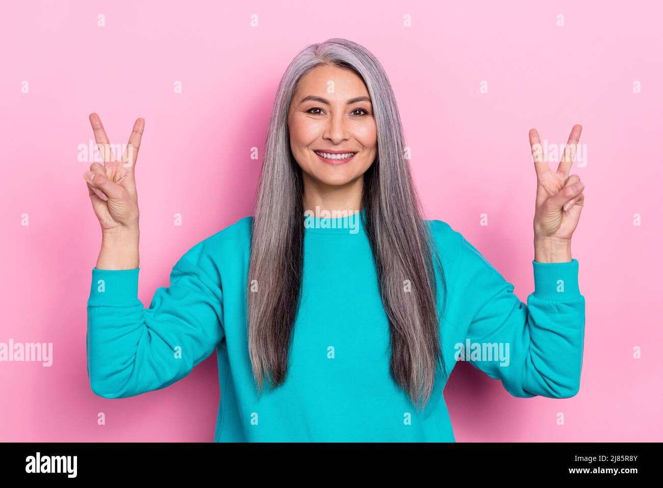 Portrait of positive nice lady two hands demonstrate v-sign isolated on ...