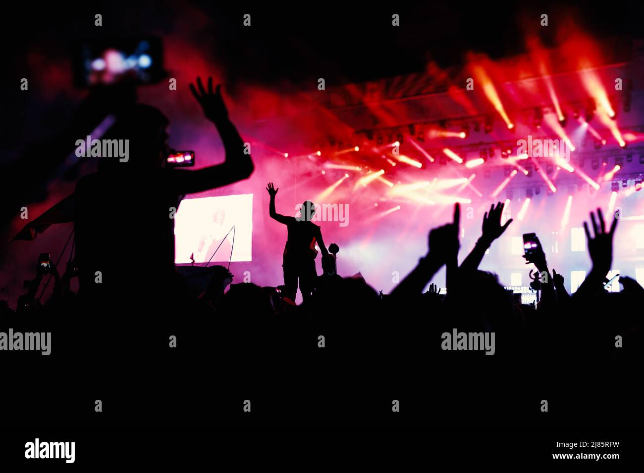 silhouettes of hands on concert in front of bright stage lights Stock ...