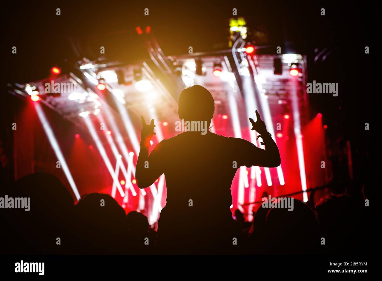 Silhouette of a man who enjoys a concert, hands up Stock Photo - Alamy