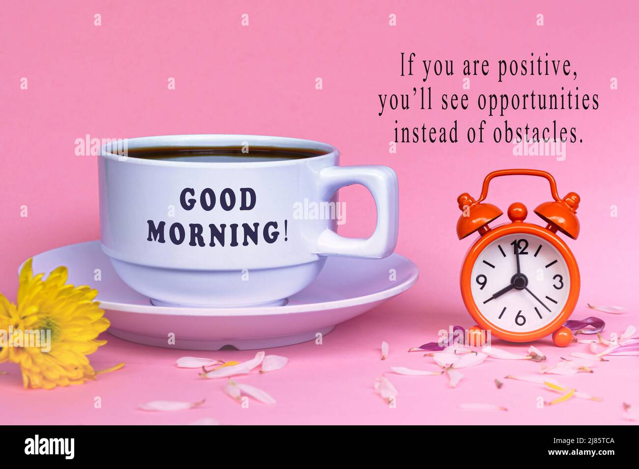 Motivational quote with white coffee cup with alarm clock set at 8 o ...