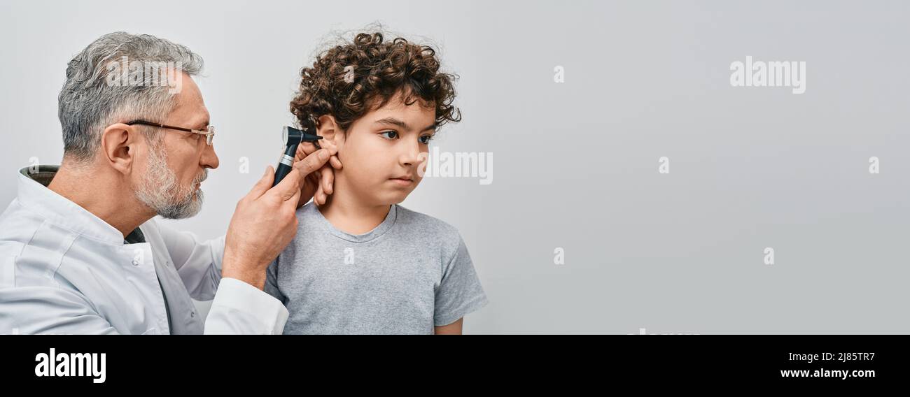 Positive curly male child while ear examining with audiologist. ENT ...