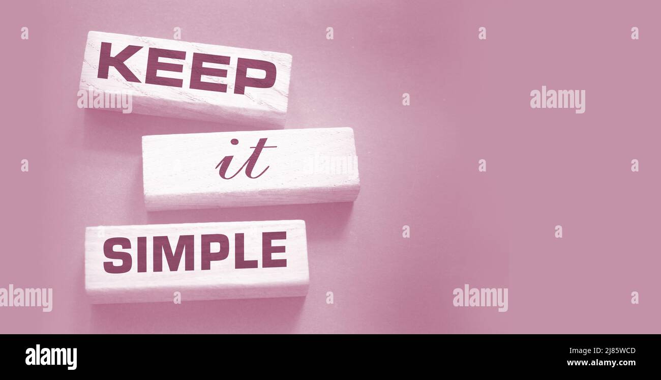 Keep it simple words on wooden blocks on dark gray background. Business ...