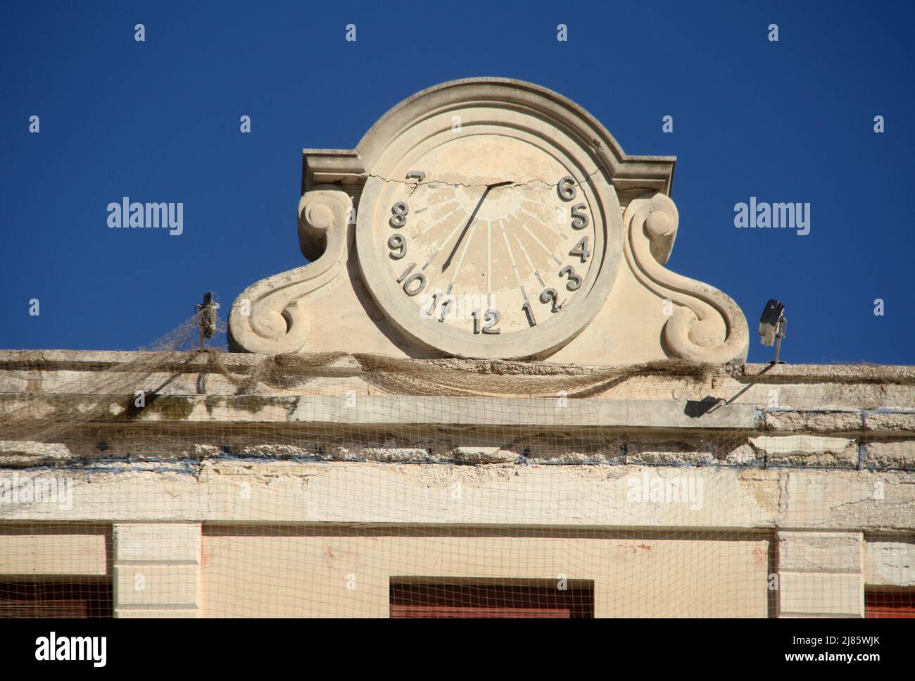 A sun dial in the architecture of an old building in Bari, Italy Stock ...