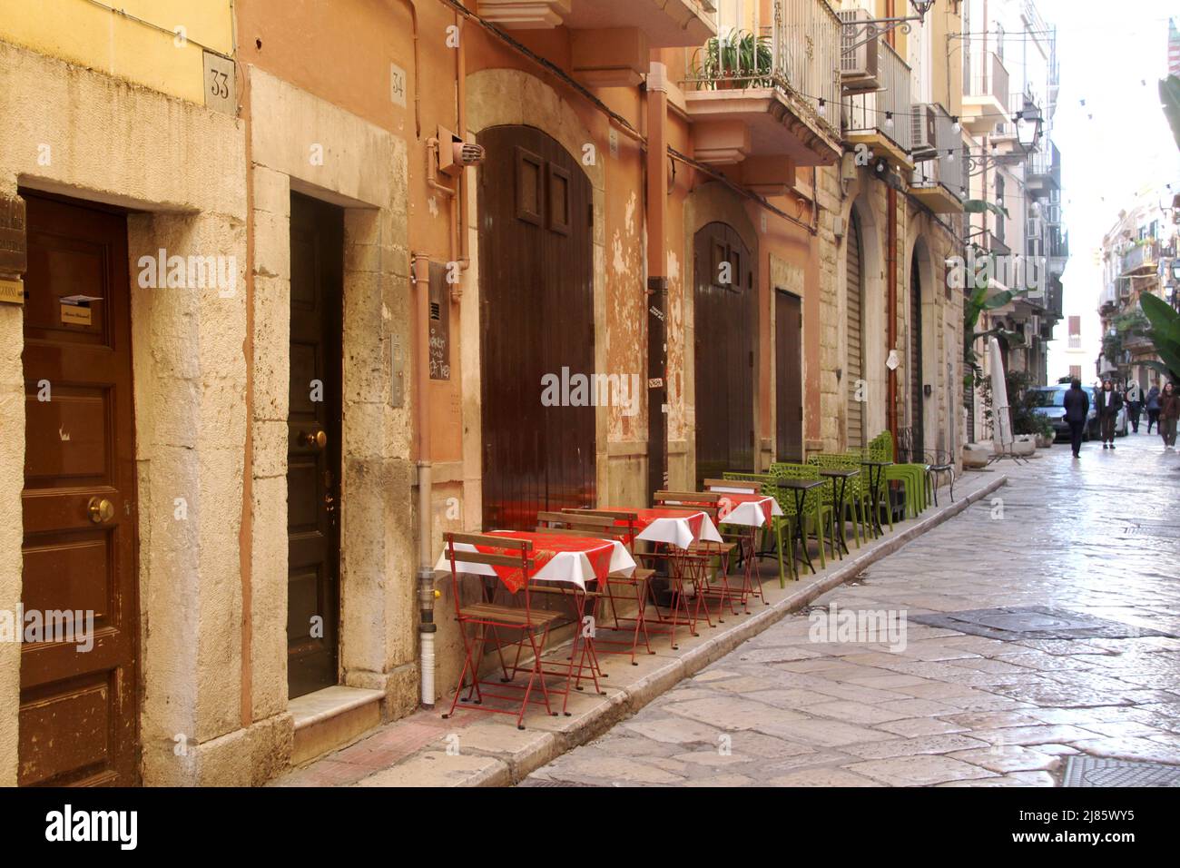 Sidewalk seating area of a cafe in the historical center of Bari, Italy ...