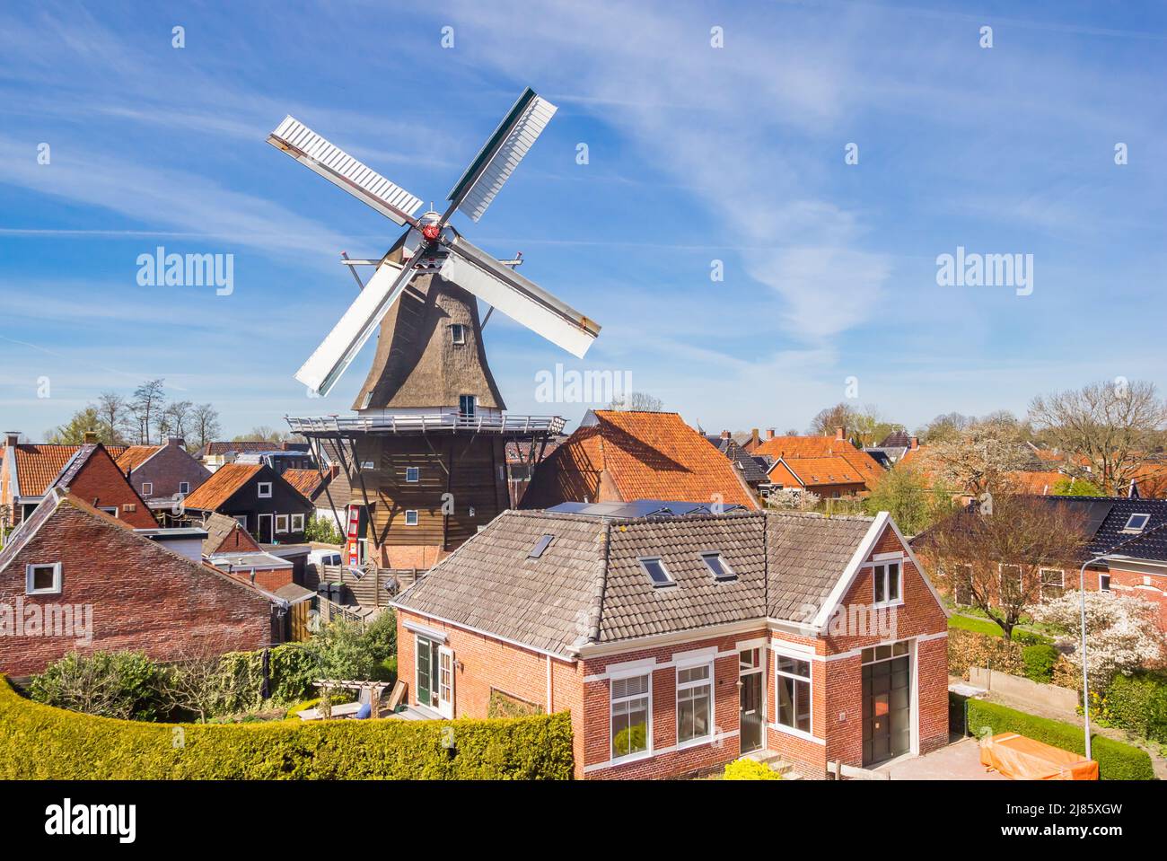 Historic windmill and typical dutch houses in Winsum, Netherlands Stock ...