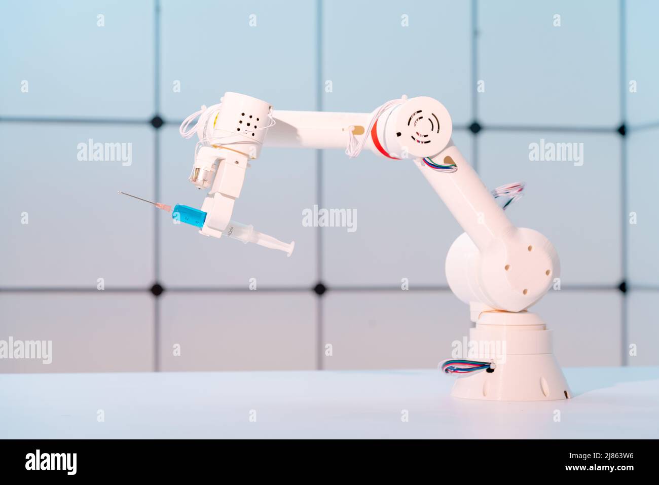 Robot hand with a medical syringe. Future medicine concept using robots ...