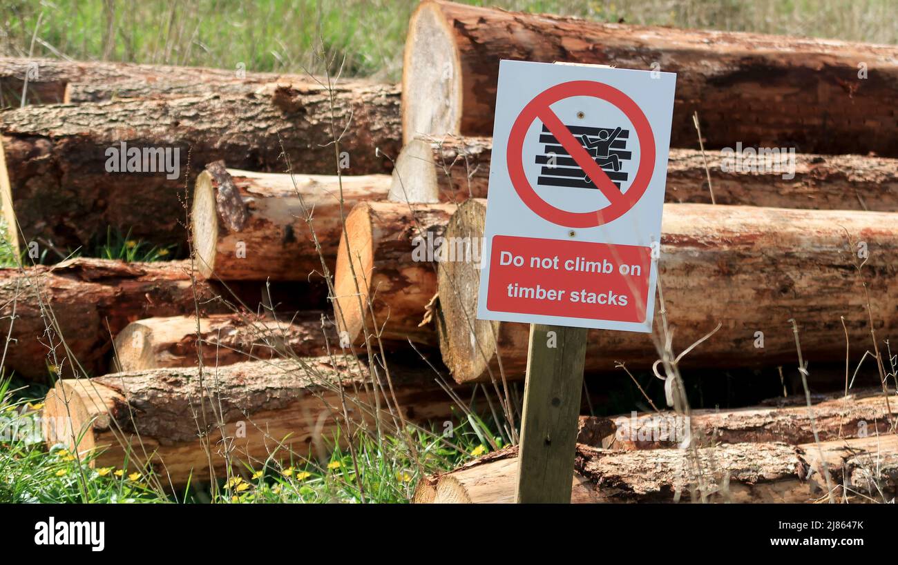 Safety sign on stacked cut timber Stock Photo - Alamy