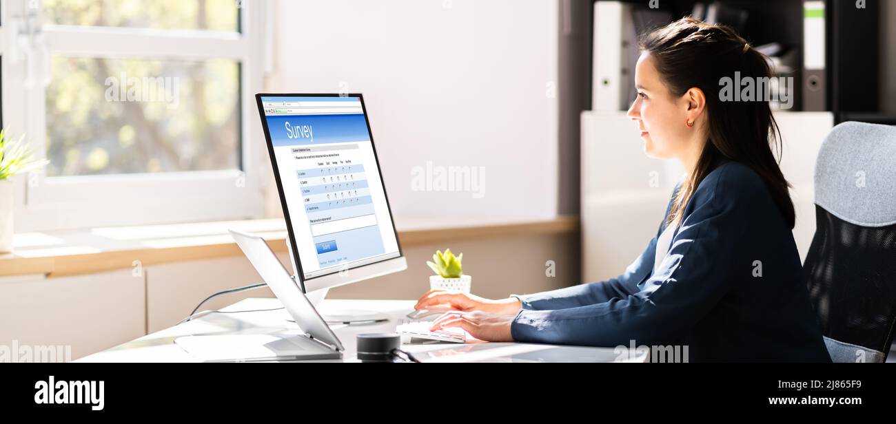Woman Filling Survey Poll Or Form On Desktop Computer Stock Photo - Alamy