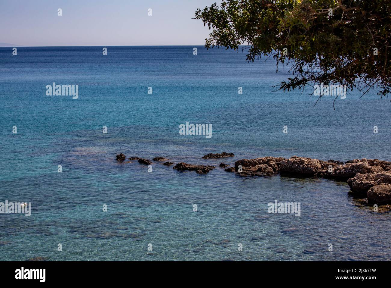 Rocks in the water, Chalki island Stock Photo - Alamy