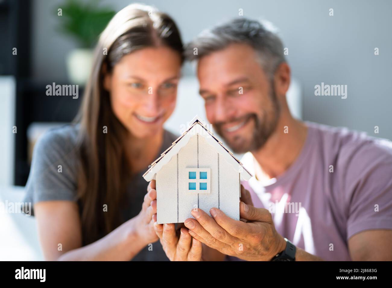Happy Family Buying New House. Couple With Real Estate In Hands Stock ...