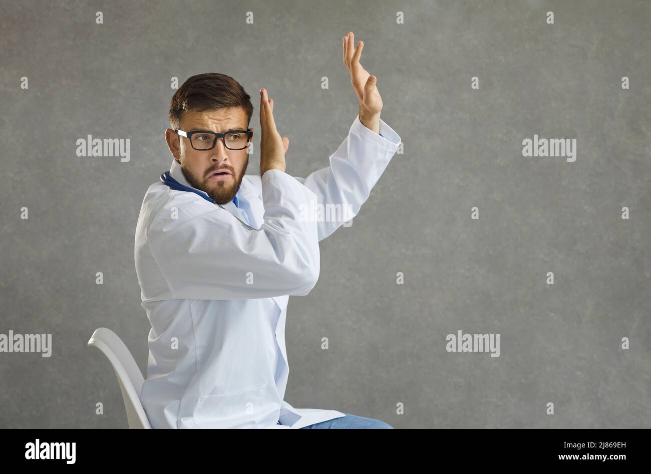 Doctor doing gesture telling to stop afraid of danger on grey copy ...