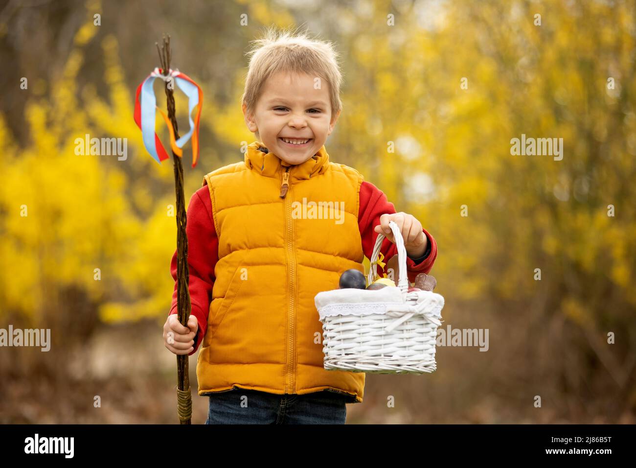 Cute preschool child, boy, holding handmade braided whip made from ...