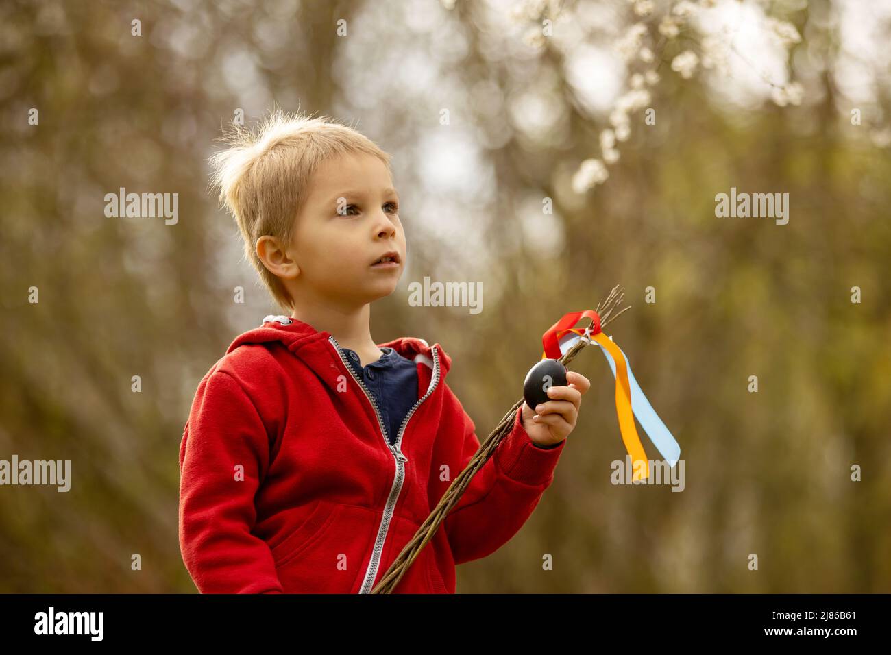 Cute preschool child, boy, holding handmade braided whip made from ...