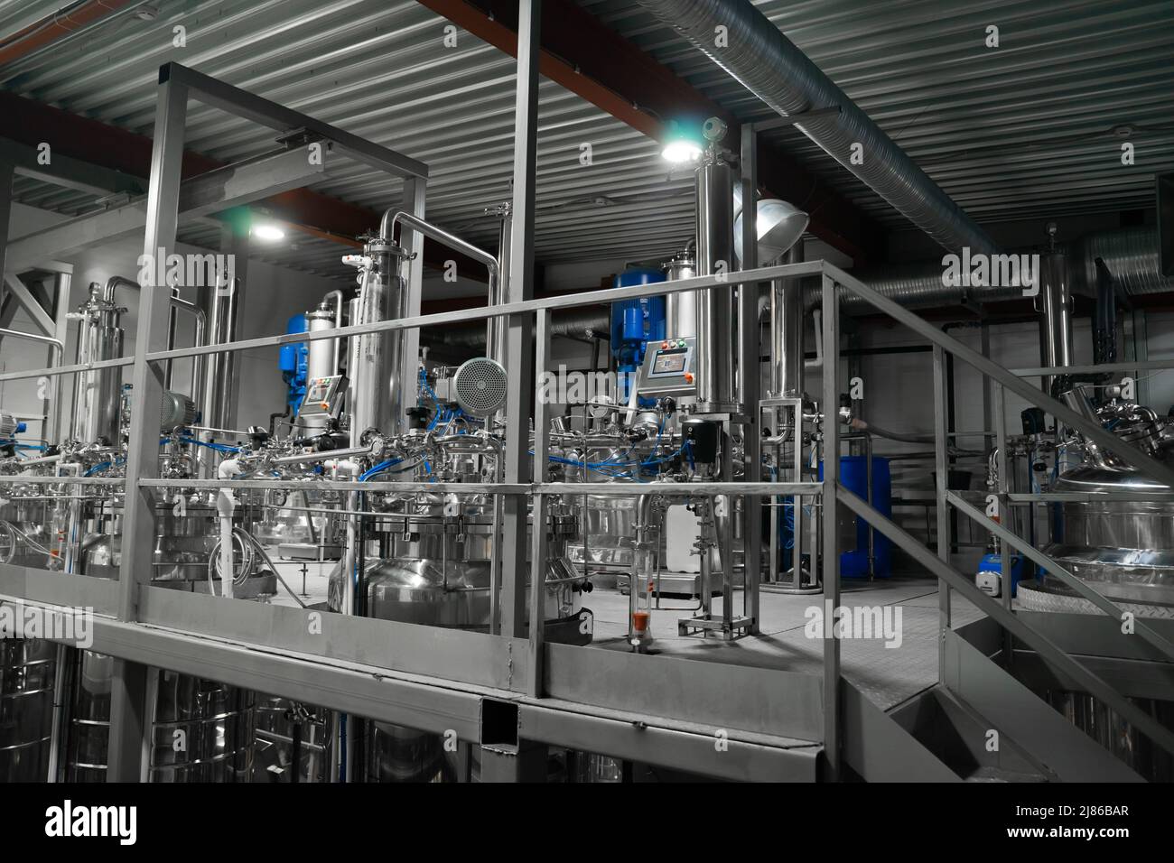 Industrial stainless steel vats. Factory interior, steel pipelines ...