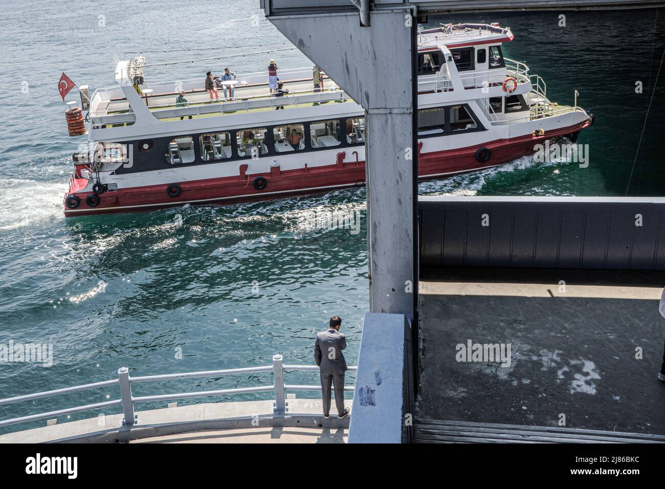 A ferry is seen as it passes under the Galata Bridge. The maritime ...