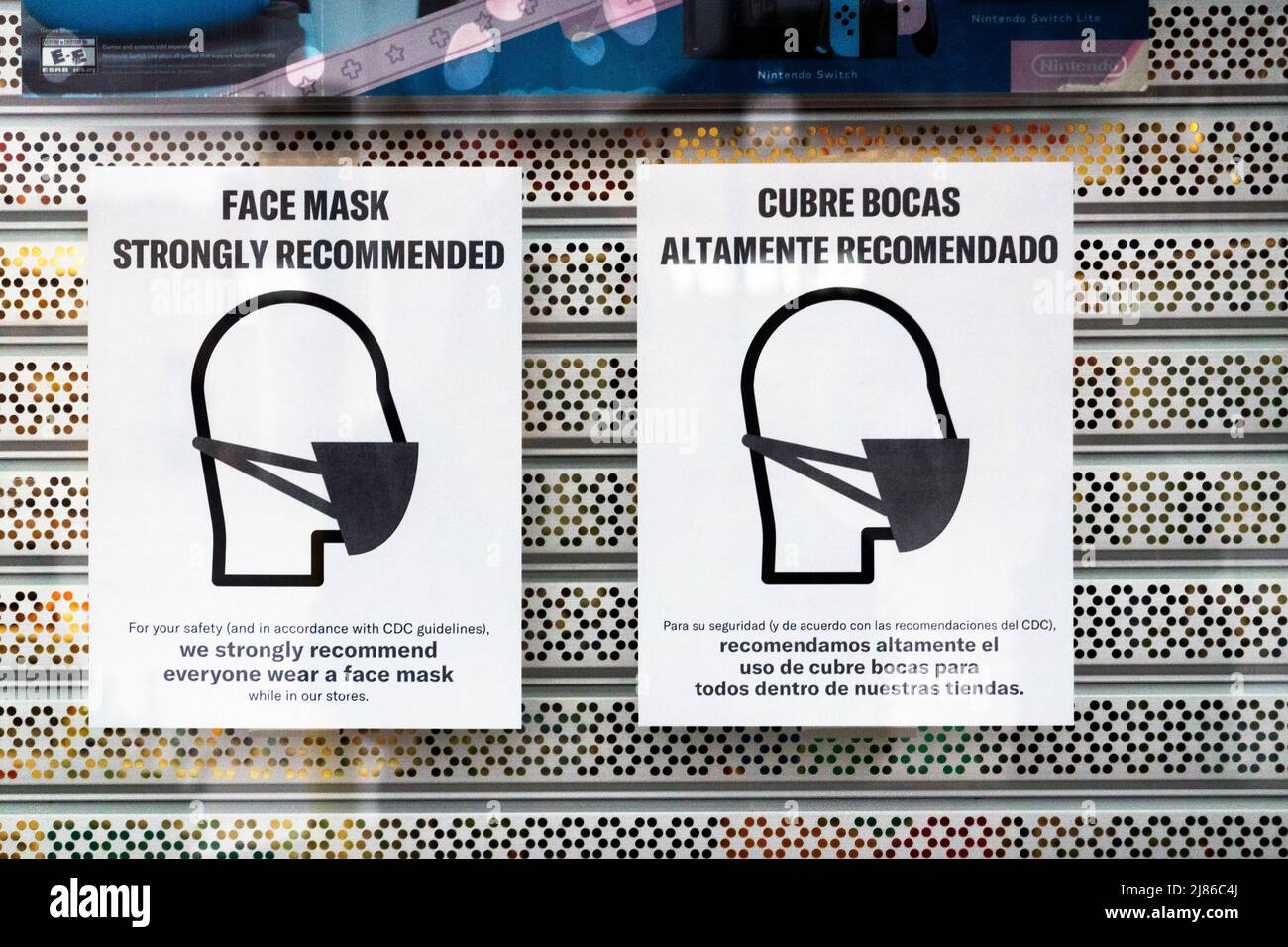 Bilingual mask signs outside a store in Astoria, Queens, New York ...
