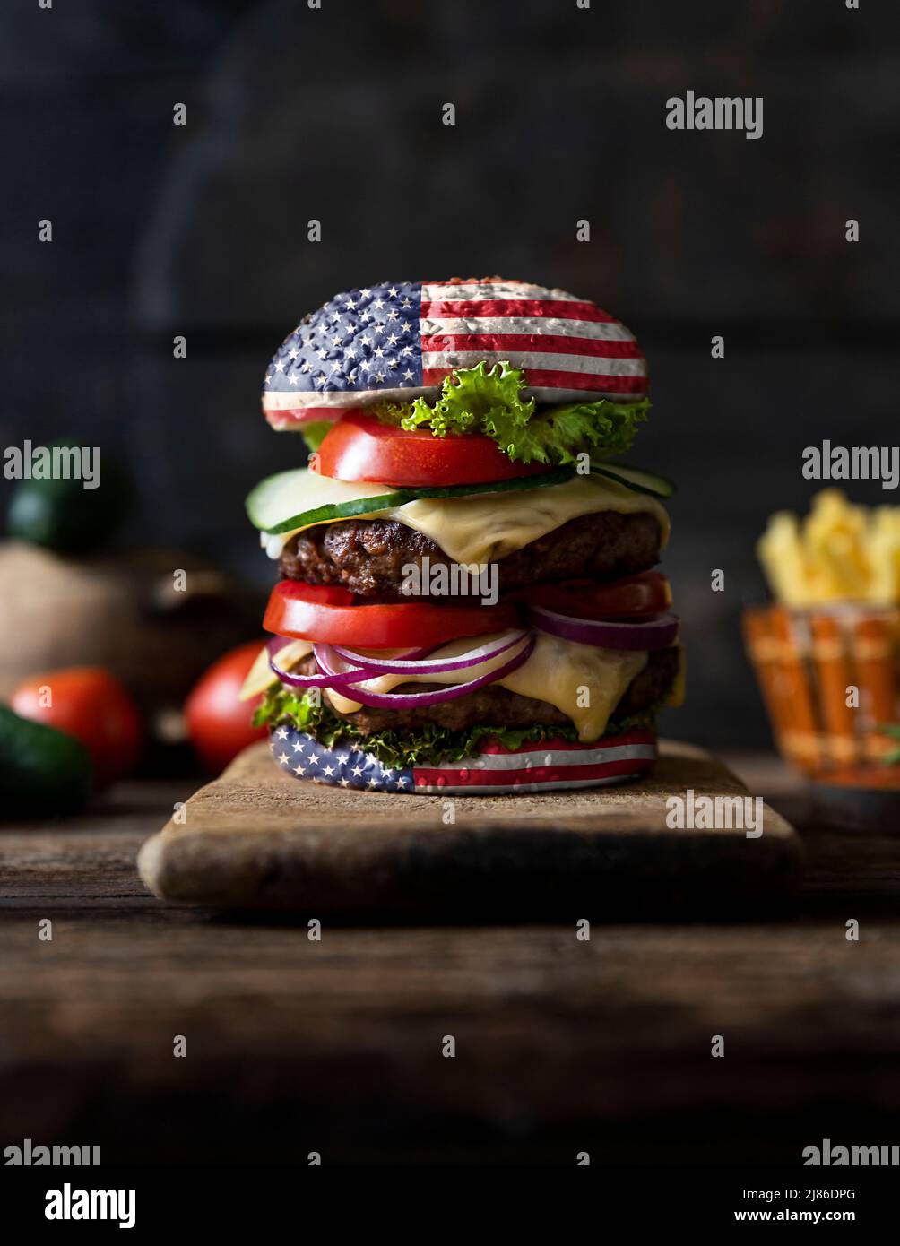 American Burger with tomatoes, onions, cucumber, lettuce and melting ...