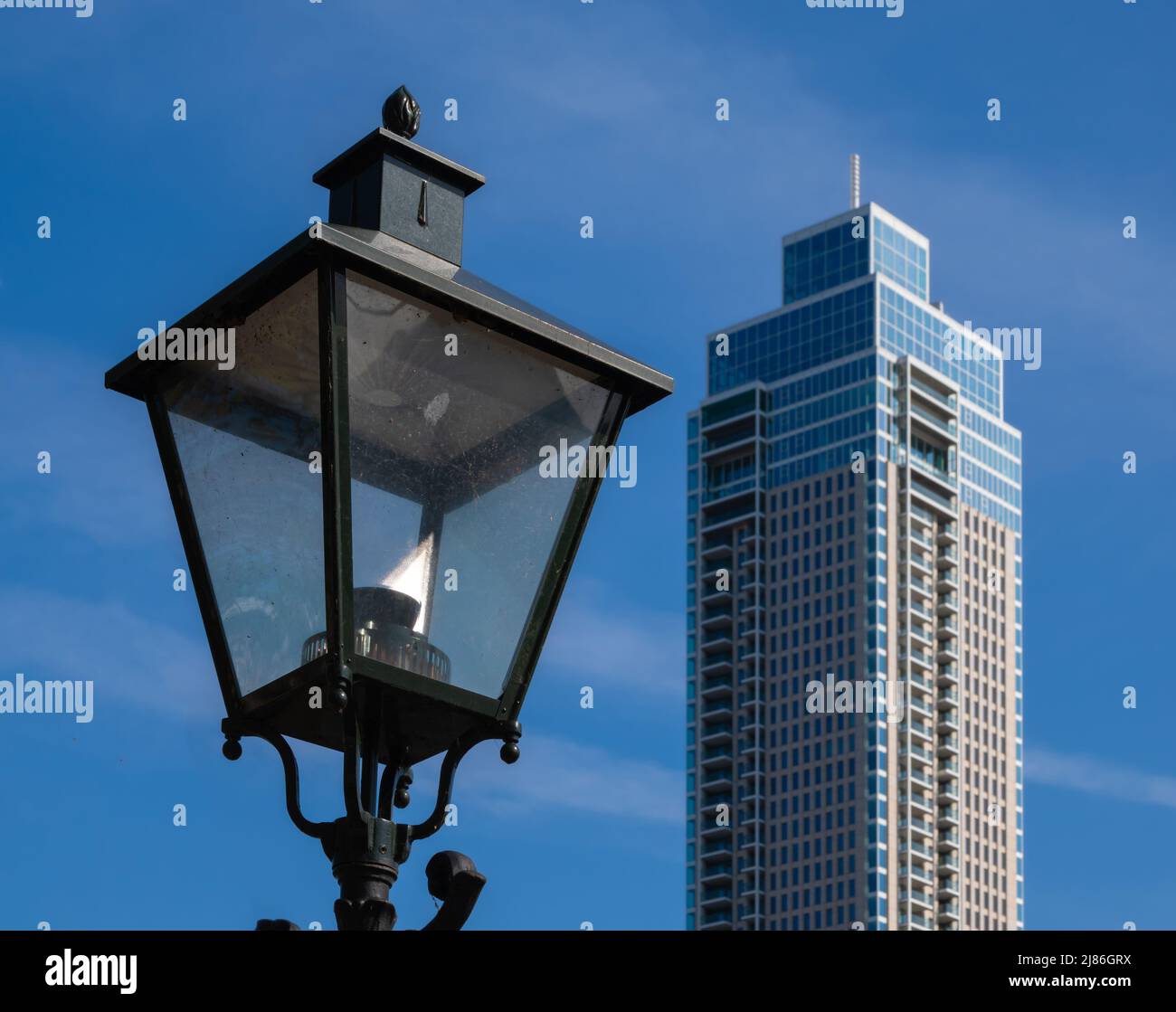 An old street lamp and part of a modern skyscraper in Rotterdam ...