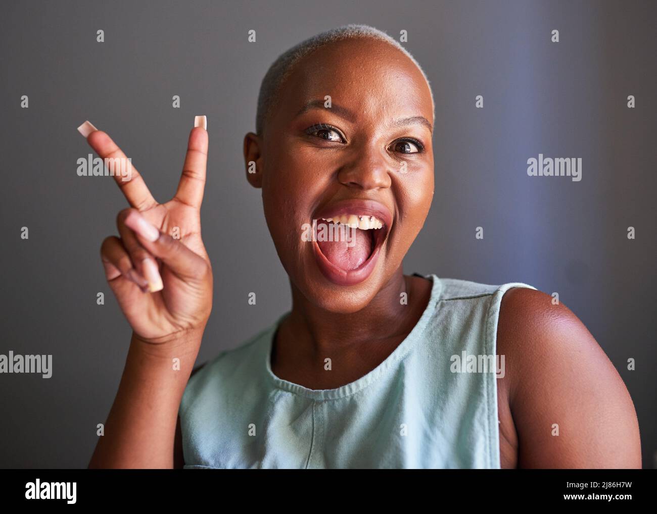 A young Black model poses with peace sign Stock Photo - Alamy