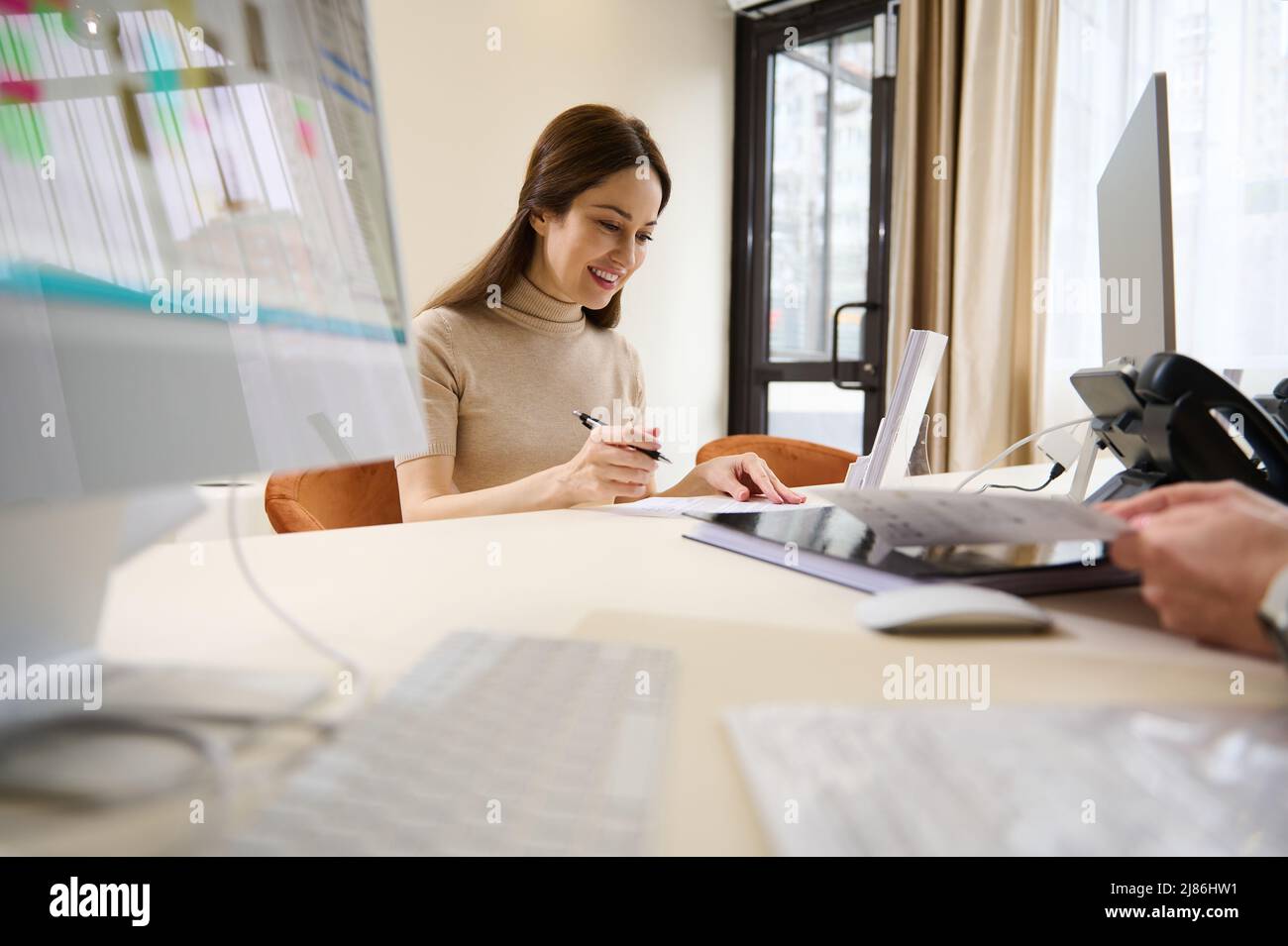 Focused charming Caucasian woman filling out questionnaire or paper ...
