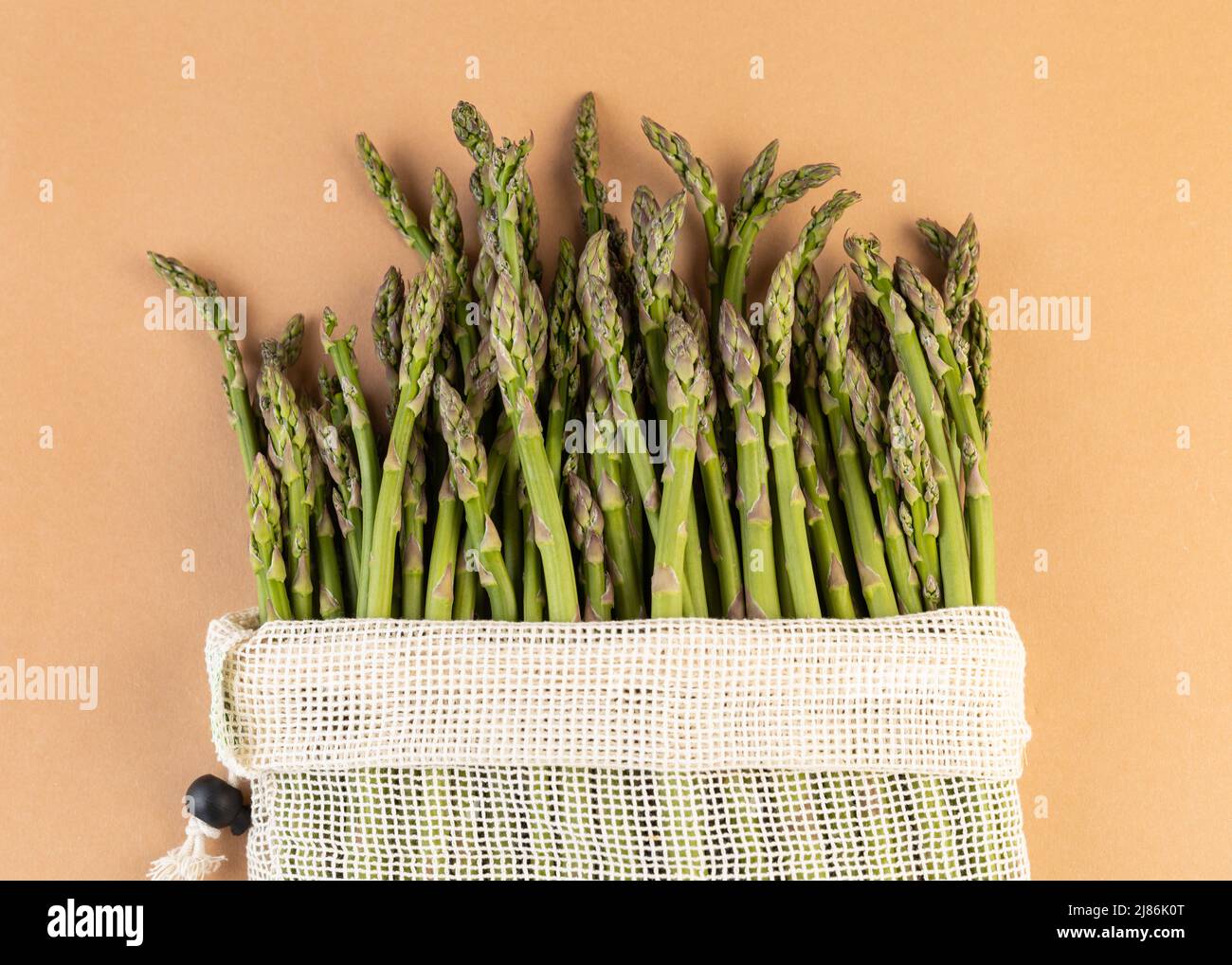Fresh green asparagus sticks in a mesh bag.. Healthy food and diet ...