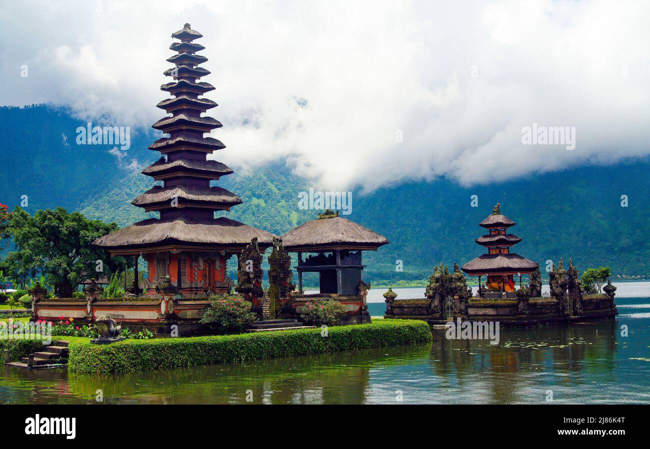 Beautiful mystic moody spiritual landscape, lake island, old hindu temple, mountains, deep misty ...