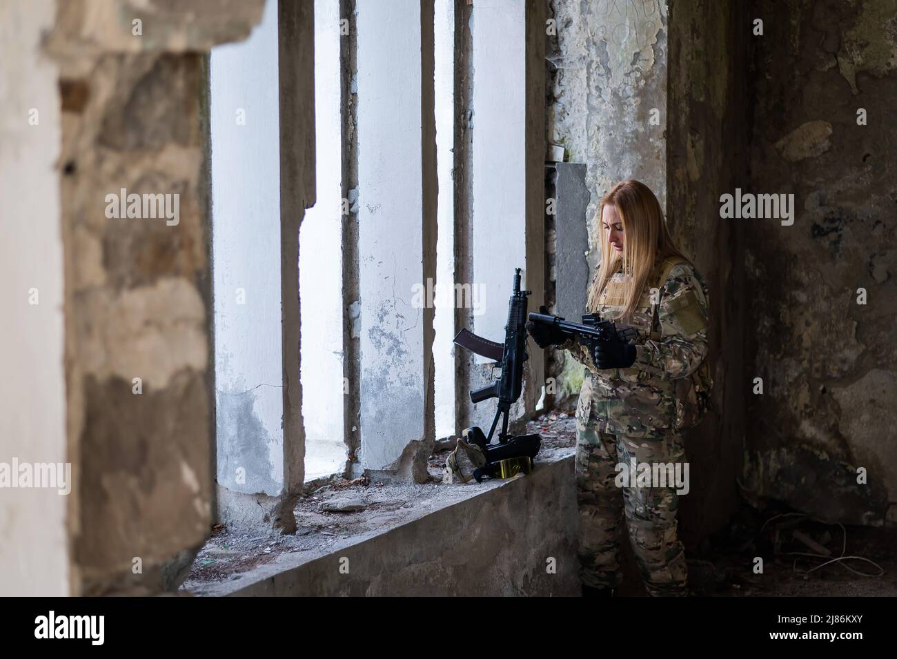 Caucasian military woman in a destroyed building Stock Photo - Alamy