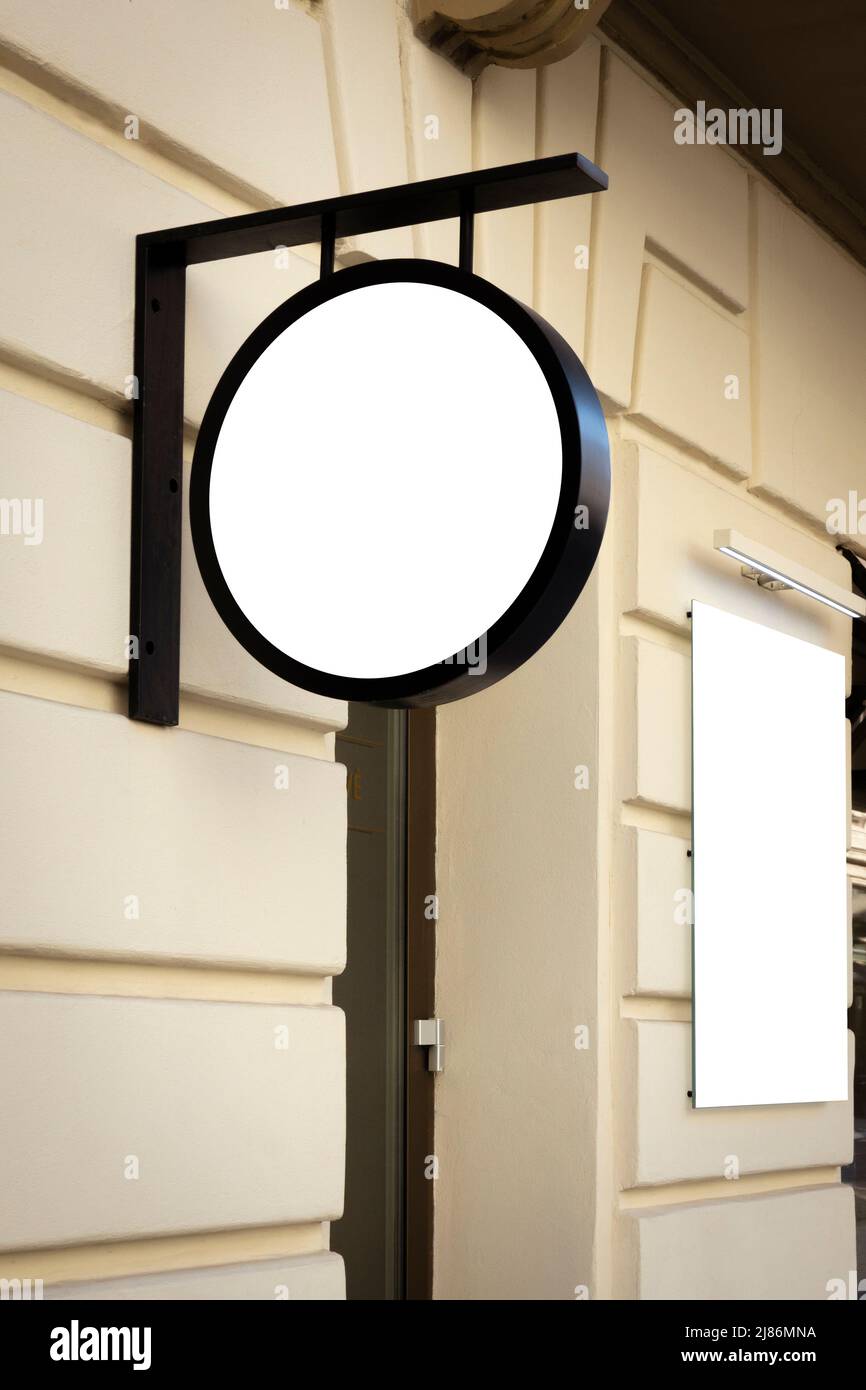 Mock up. Empty white round signage and vertical rectangular signboard ...