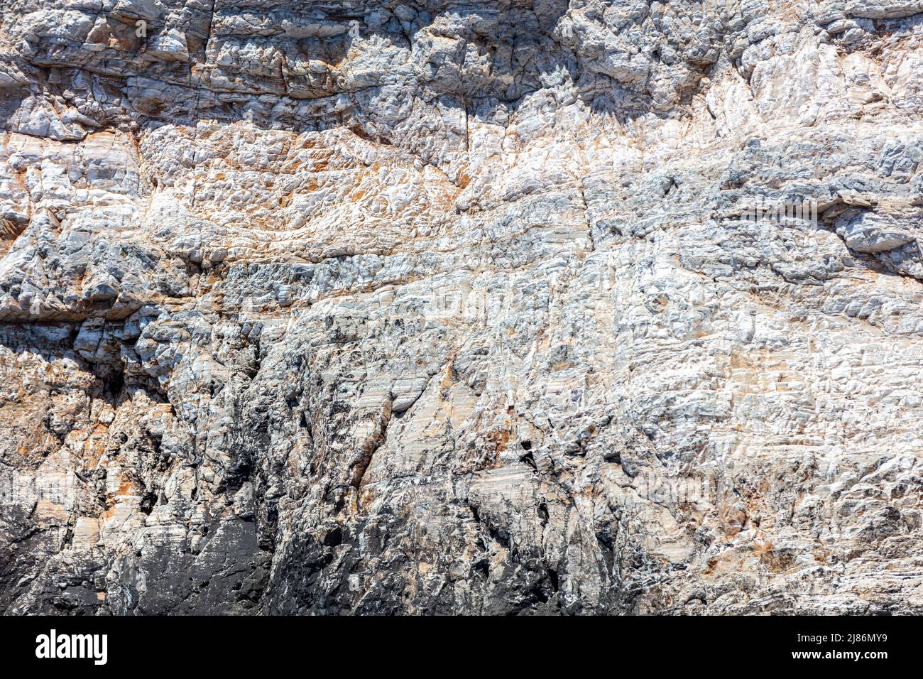 Grey rock shaped by the sea, salt and wind background texture. Stone ...