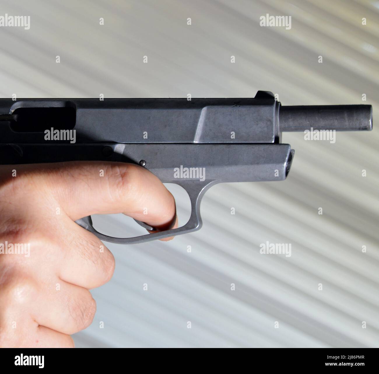 a man holding a pistol Stock Photo - Alamy