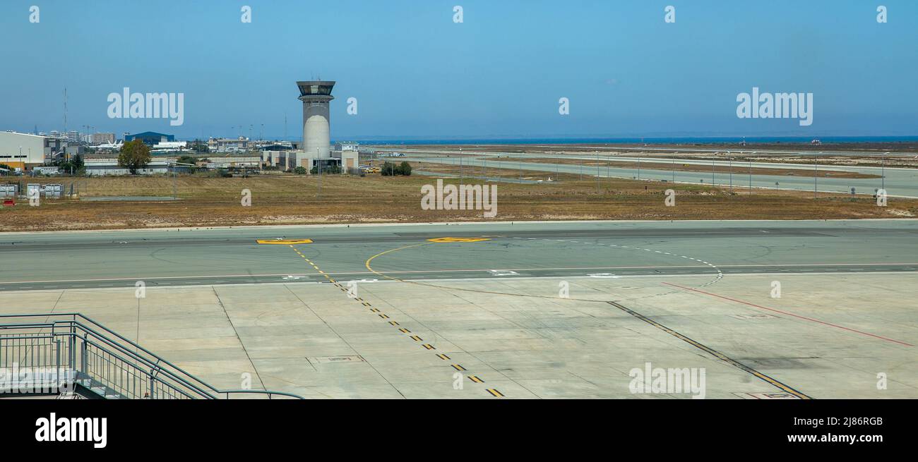 Control tower and runway in airport close to the sea Stock Photo - Alamy