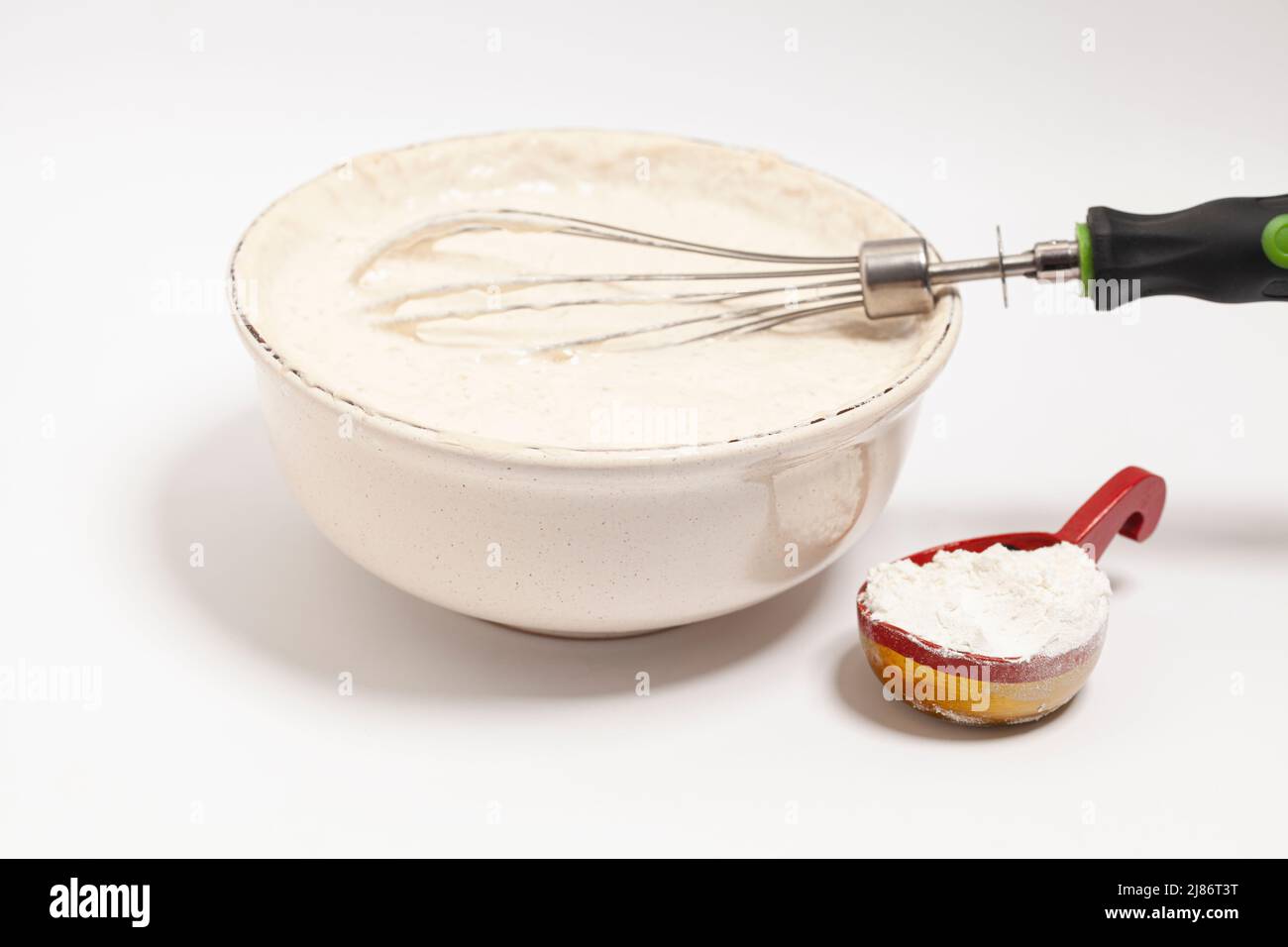 MIxing baking ingredients with dry yeast isolated on white background ...
