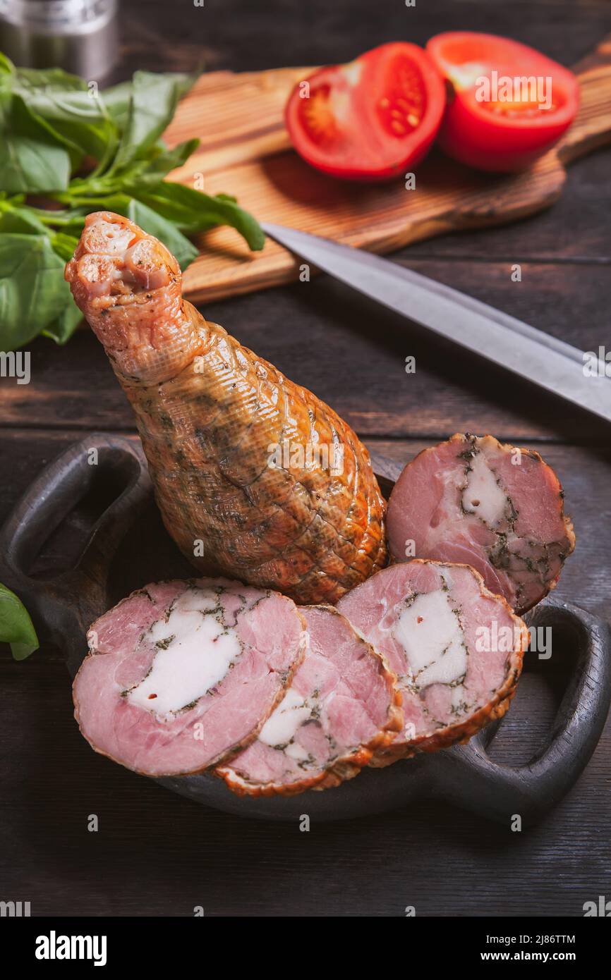 Slicing from a homemade artisan turkey meat, boiled and smoked with the ...