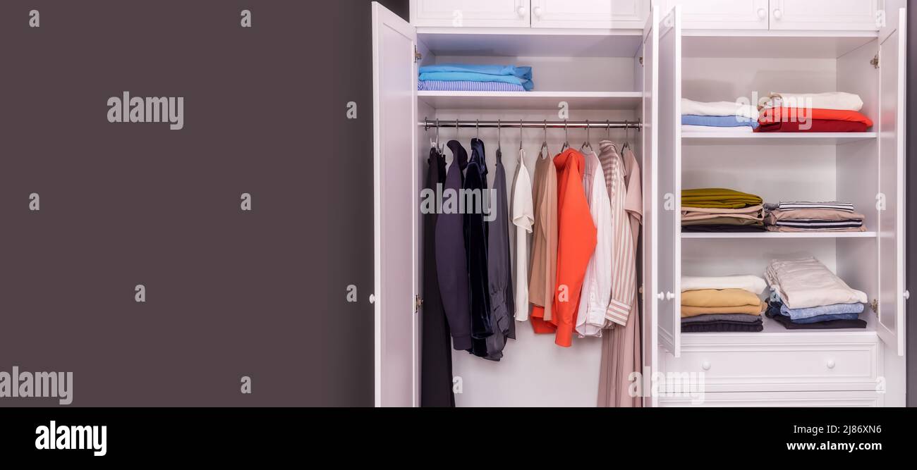 wardrobe with stylish women's clothing in perfect order. Copy paste for ...