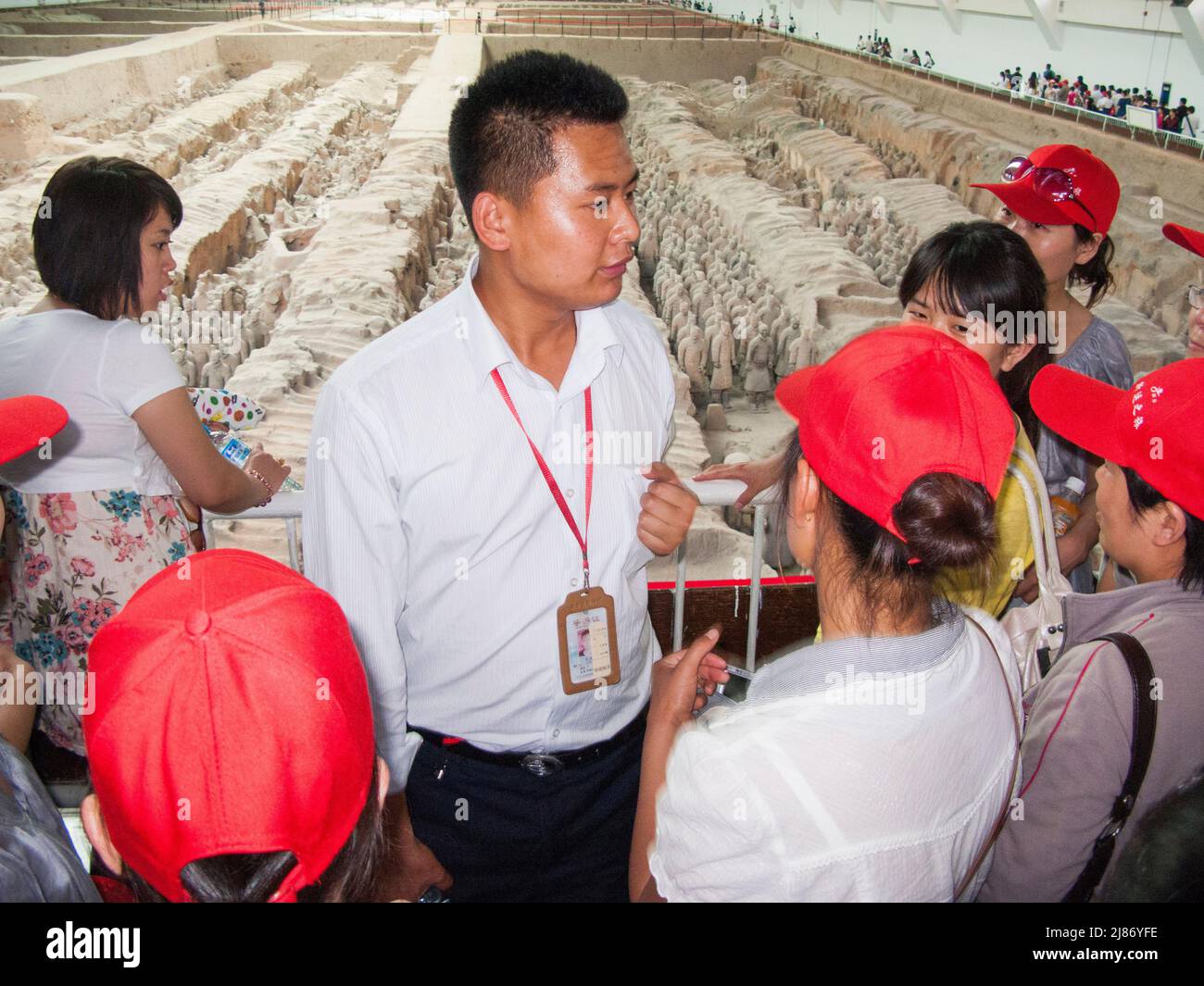 Tourist guide with a party of Chinese tourists visiting / viewing pit 1 ...