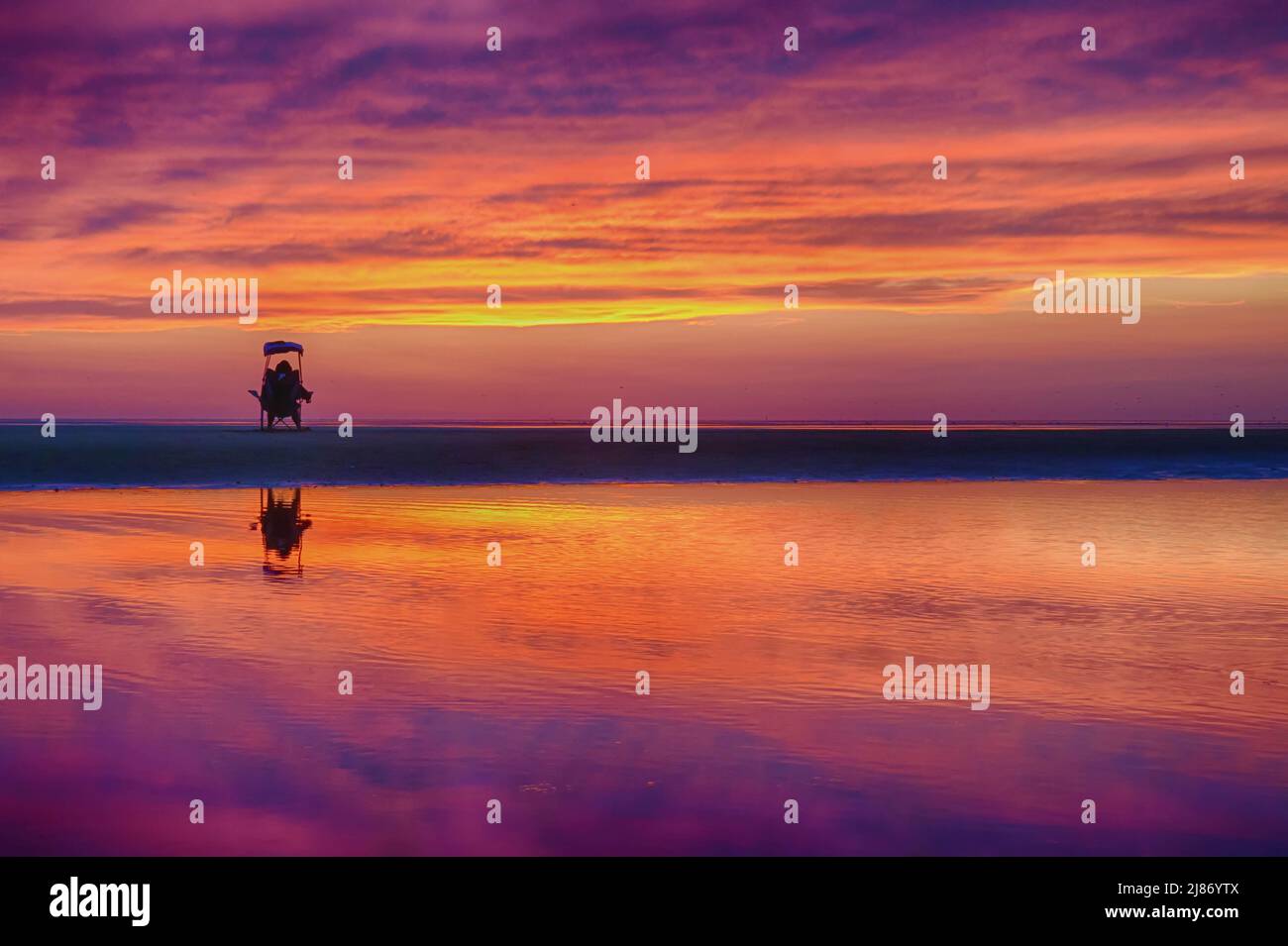 Solitary person watching colorful sunset over Cape Cod Bay Stock Photo ...