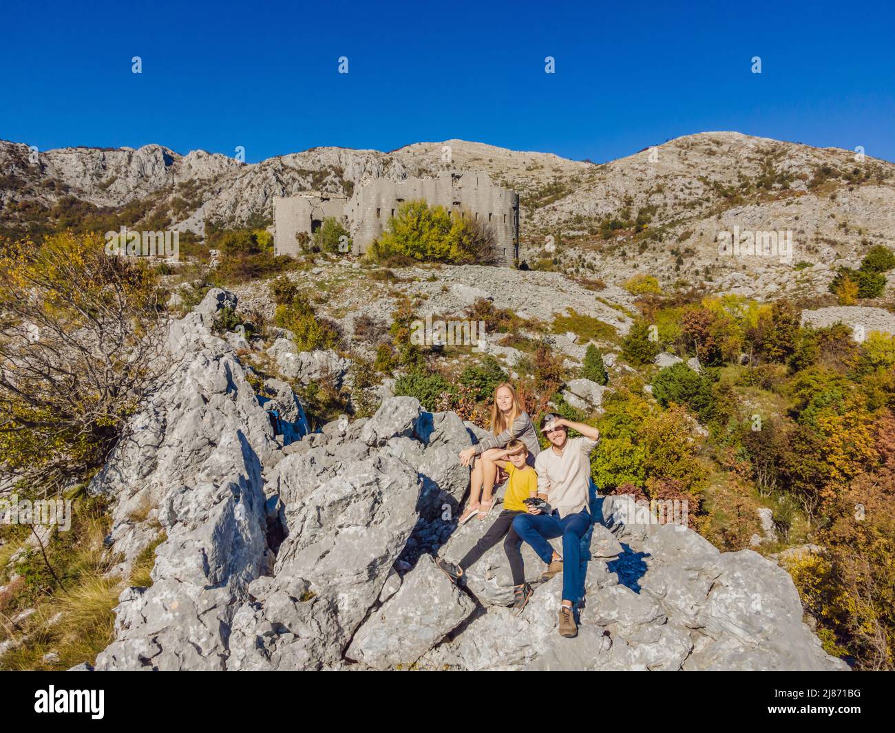 Happy family on the background of Collapsing tower of fortress Kosmac ...