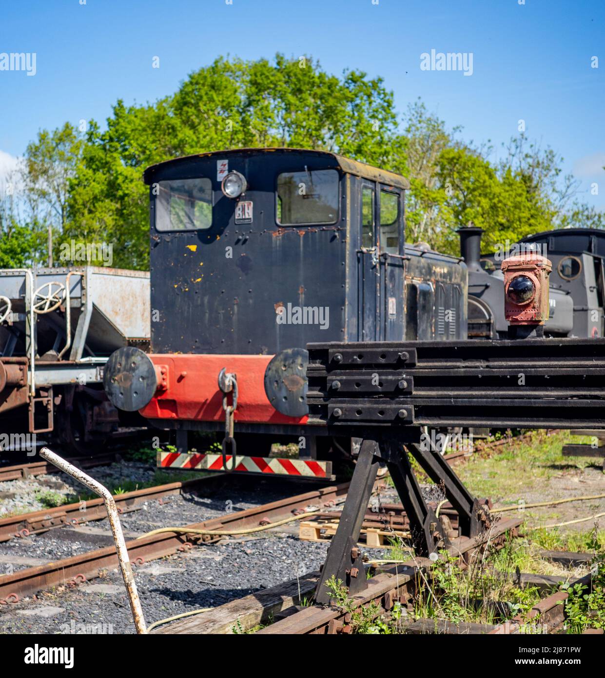Metal barrier and old, historic and abandoned steam locomotives ...