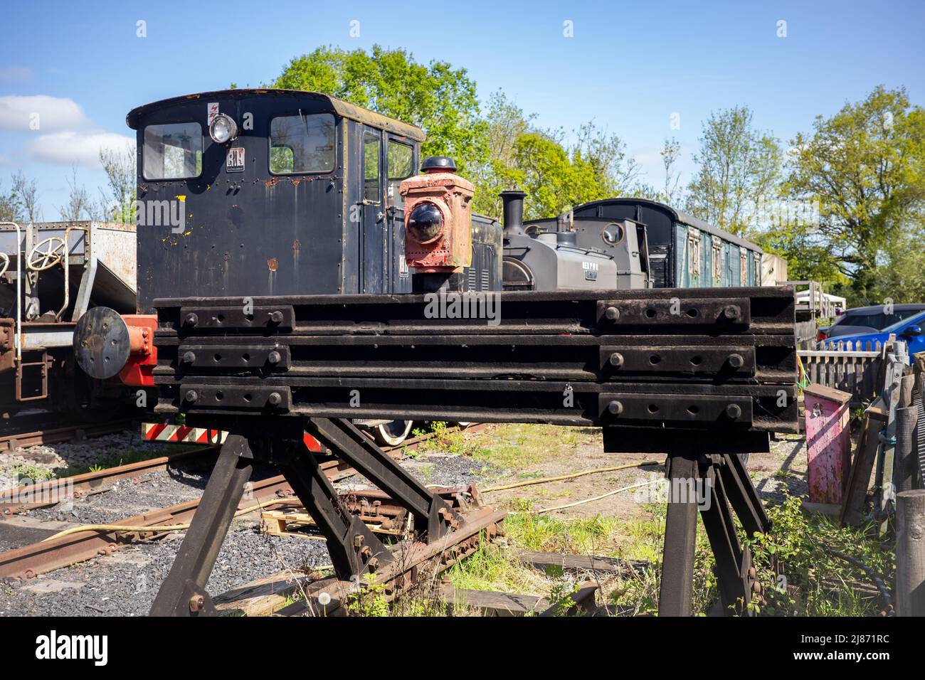 Metal barrier and old, historic and abandoned steam locomotives ...