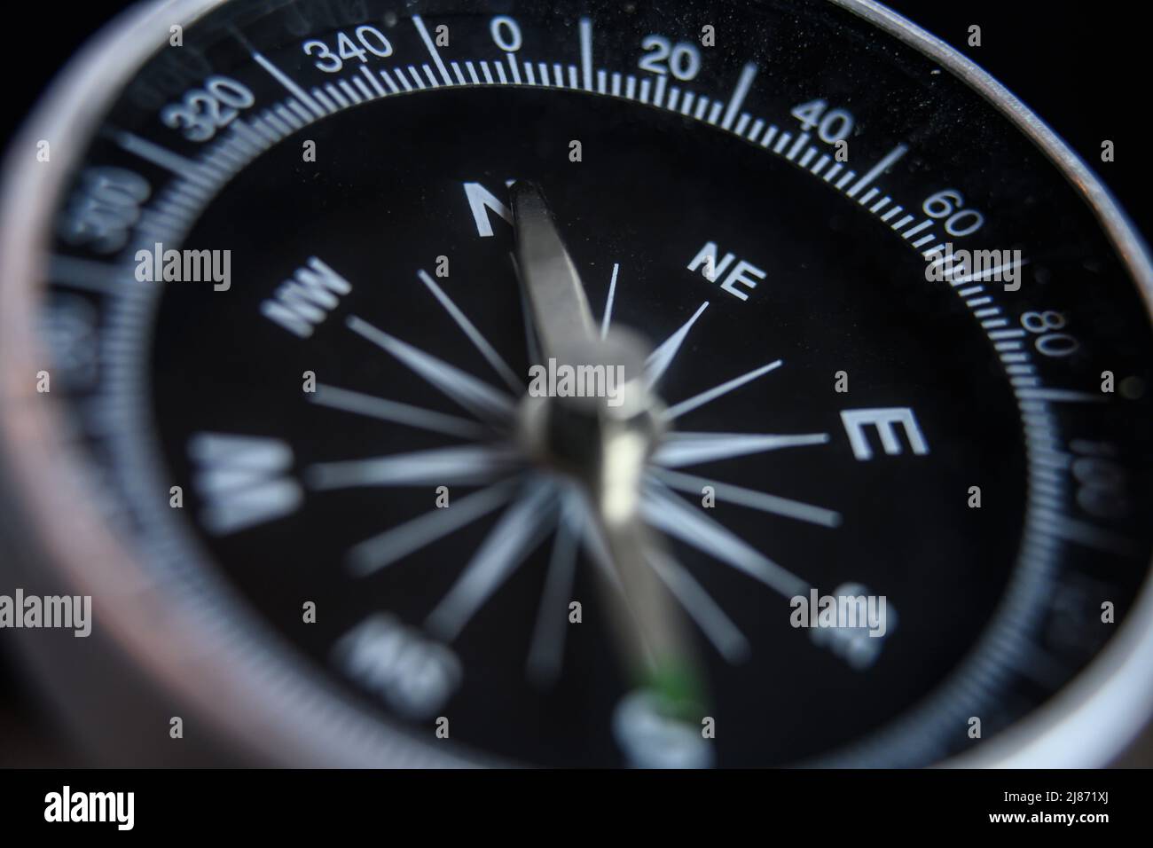 Metal magnetic compass pointing north macro shot background Stock Photo ...