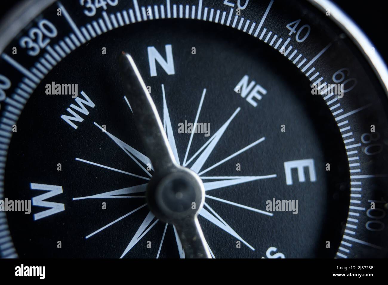 Metal magnetic compass pointing north macro shot background Stock Photo ...