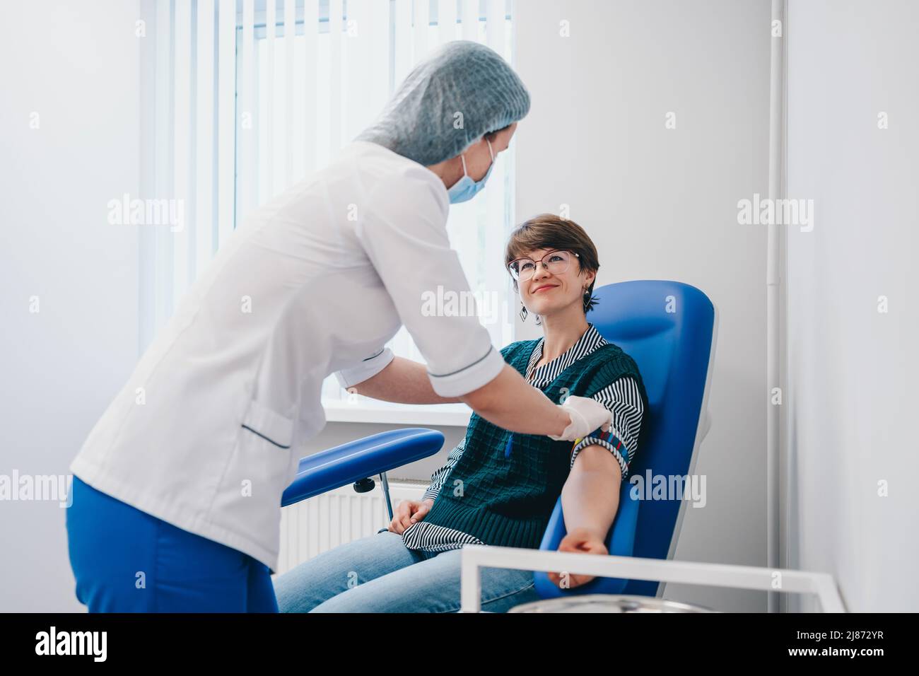 The patient takes a blood test at the clinic Stock Photo - Alamy