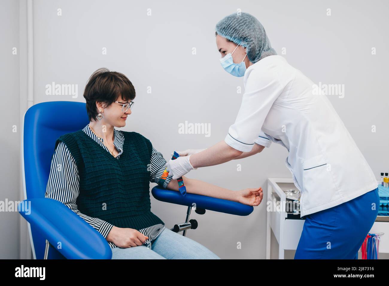 The patient takes a blood test at the clinic Stock Photo - Alamy