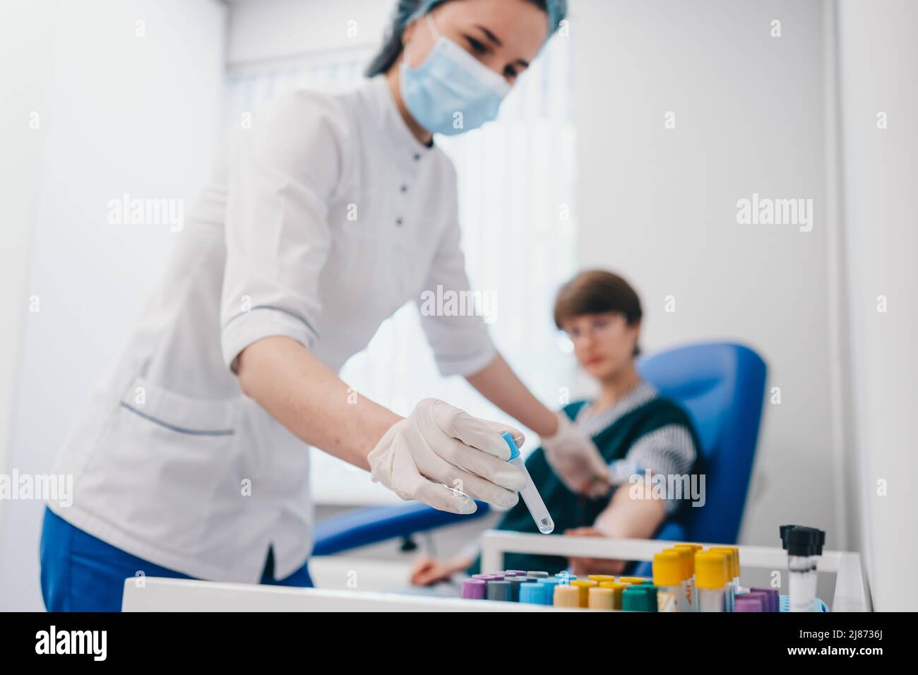 The doctor took a blood sample from the patient. Test tubes with blood ...