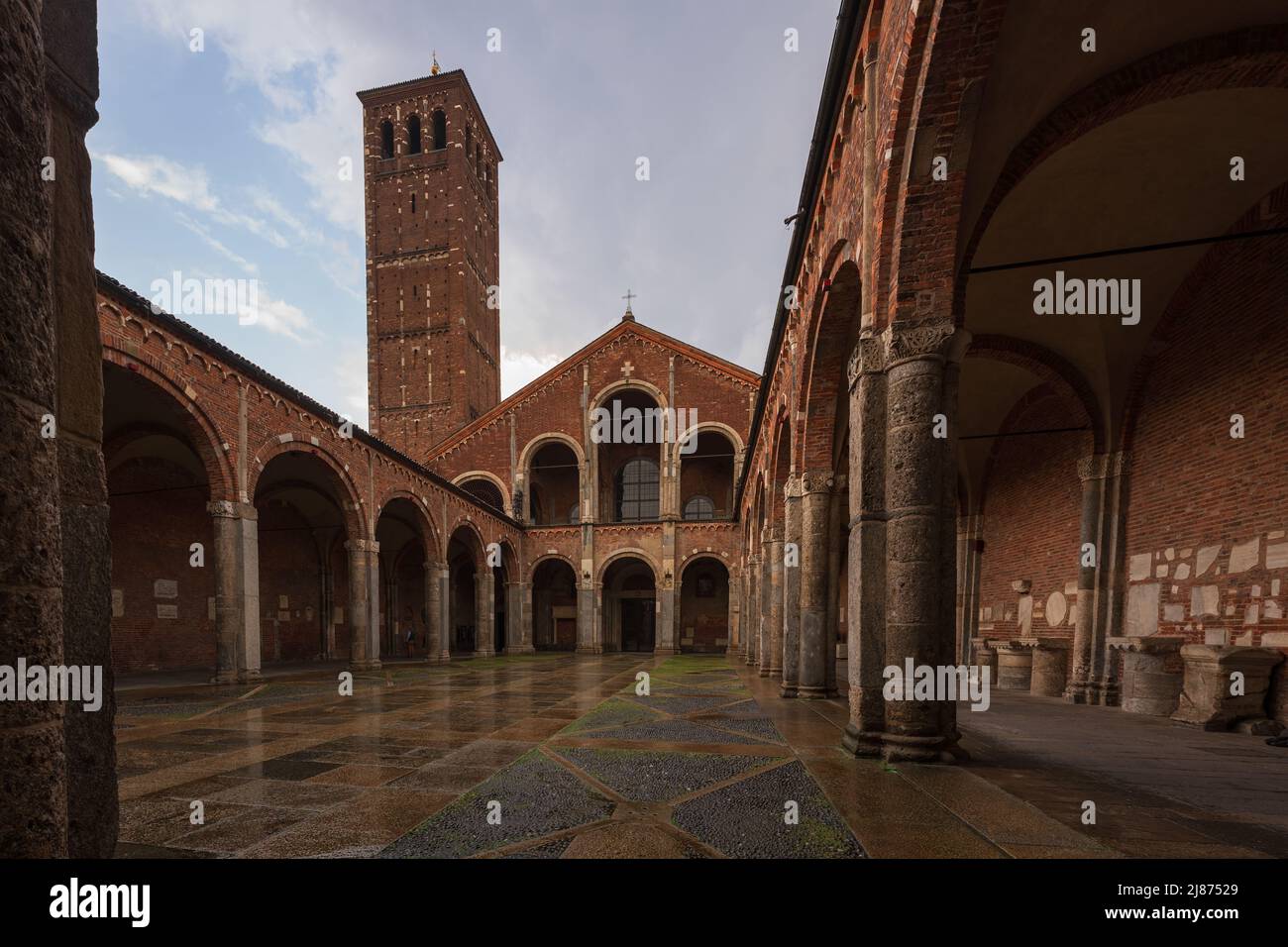 Saint Ambrogio church brick building with bell towers, courtyard ...