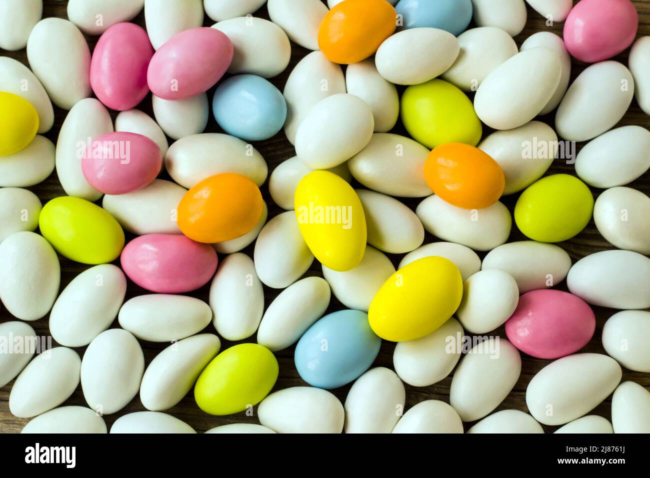 Pastel tones colored and chocolate covered almond candies background ...